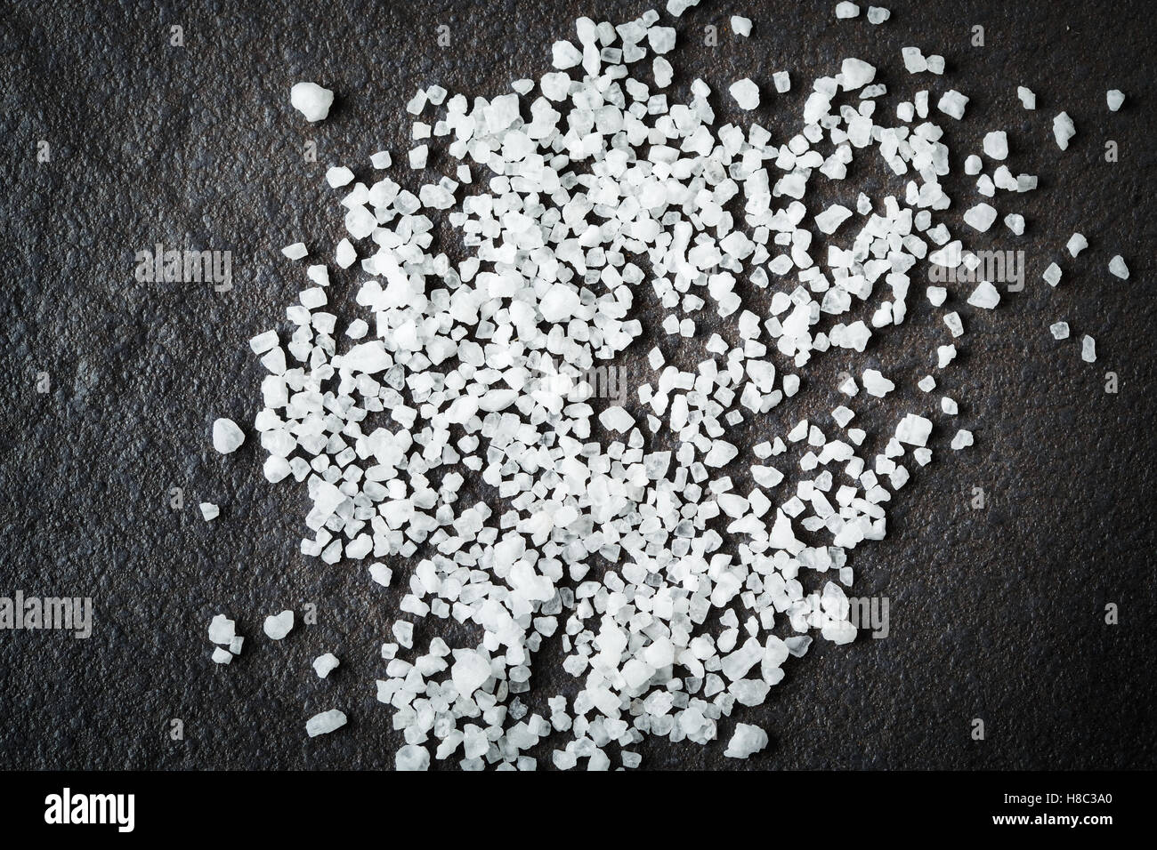 Natural organic rock salt on dark background Stock Photo - Alamy