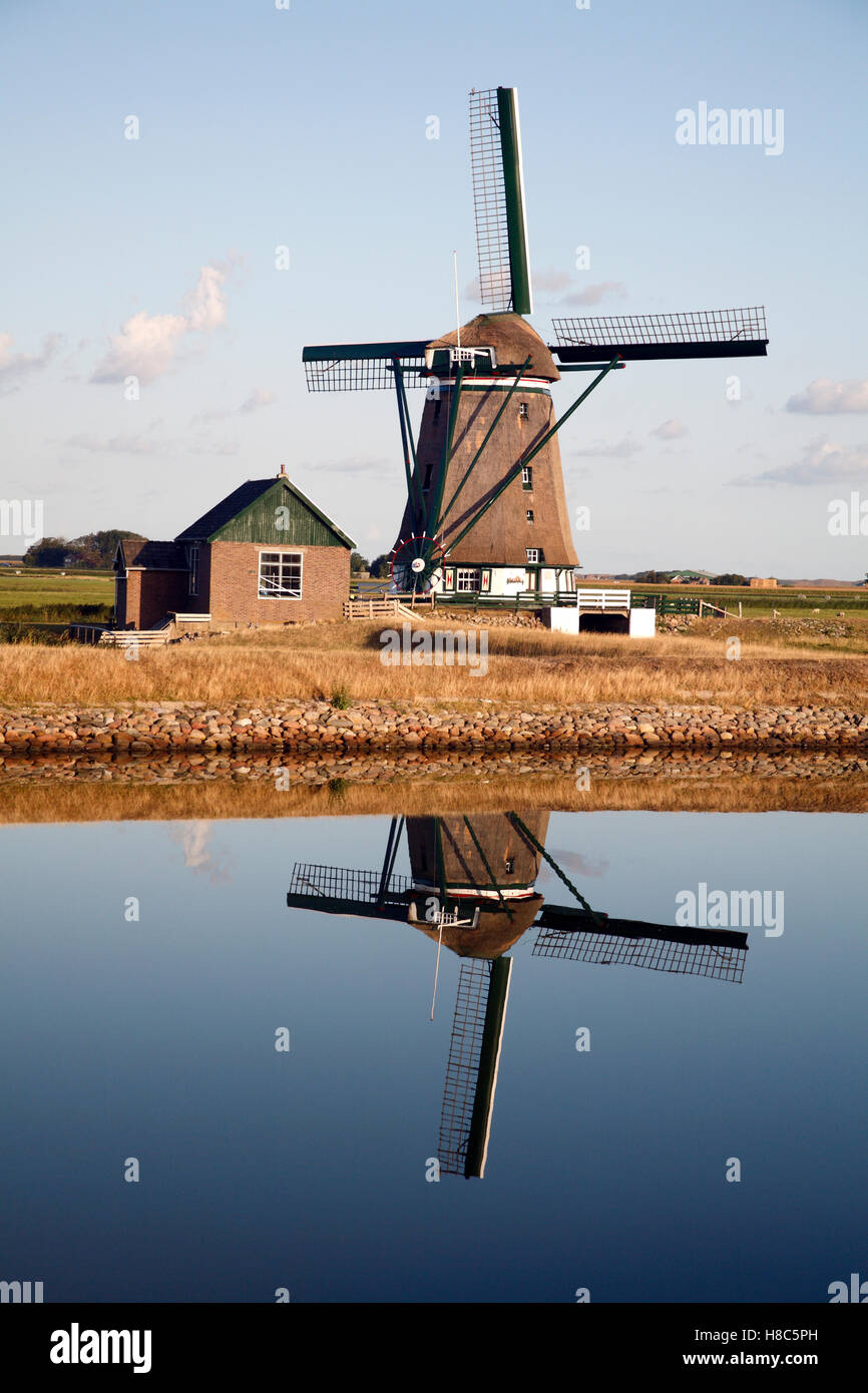 Windmill reflected in water Stock Photo - Alamy