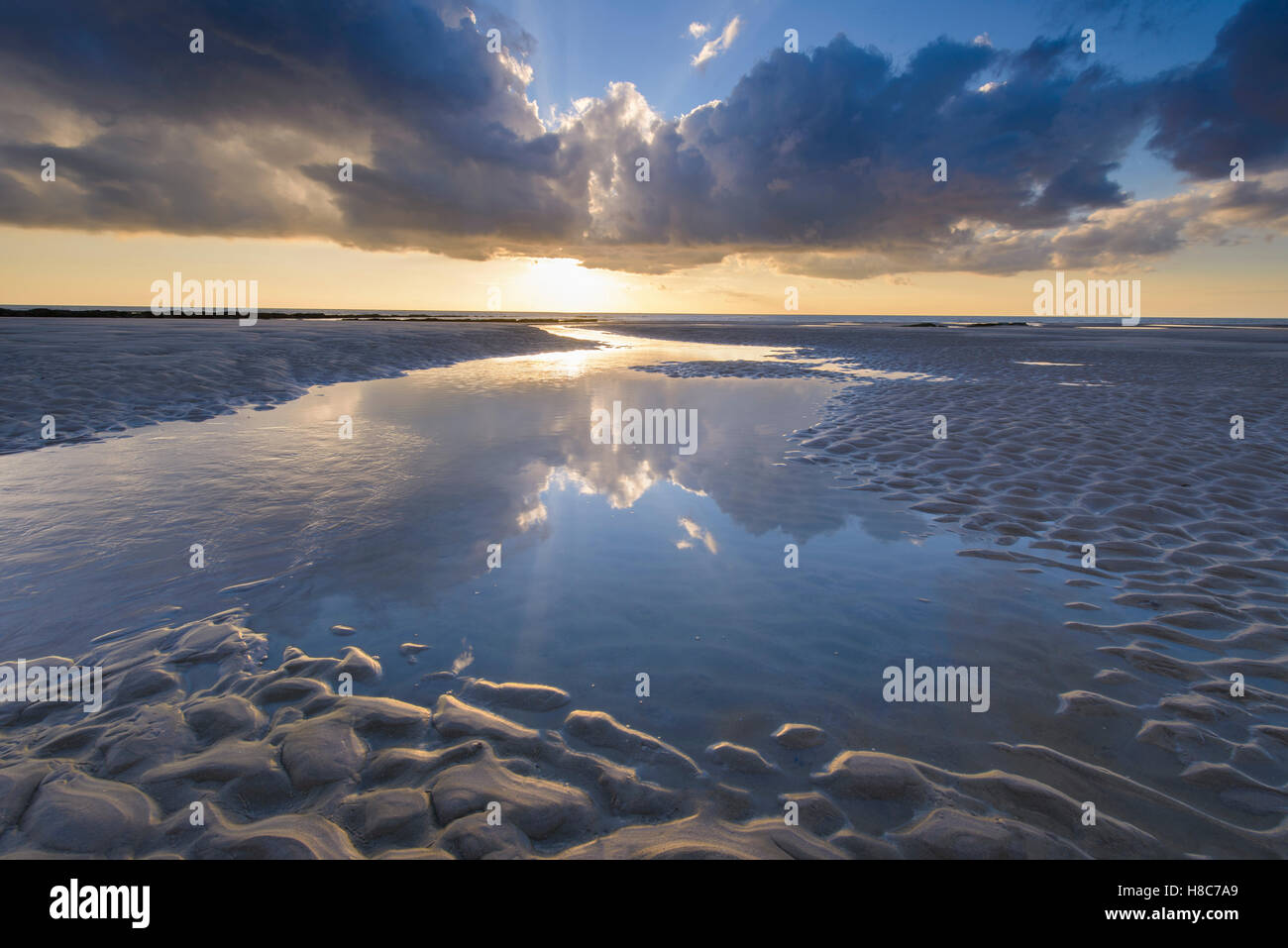 Tidal channel and storm clouds, France Stock Photo - Alamy
