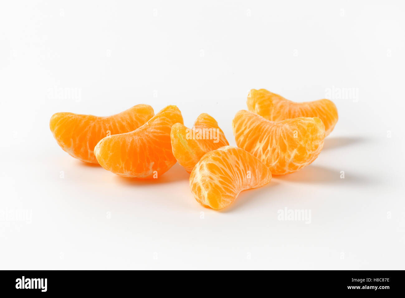 separated segments of tangerine on white background Stock Photo - Alamy