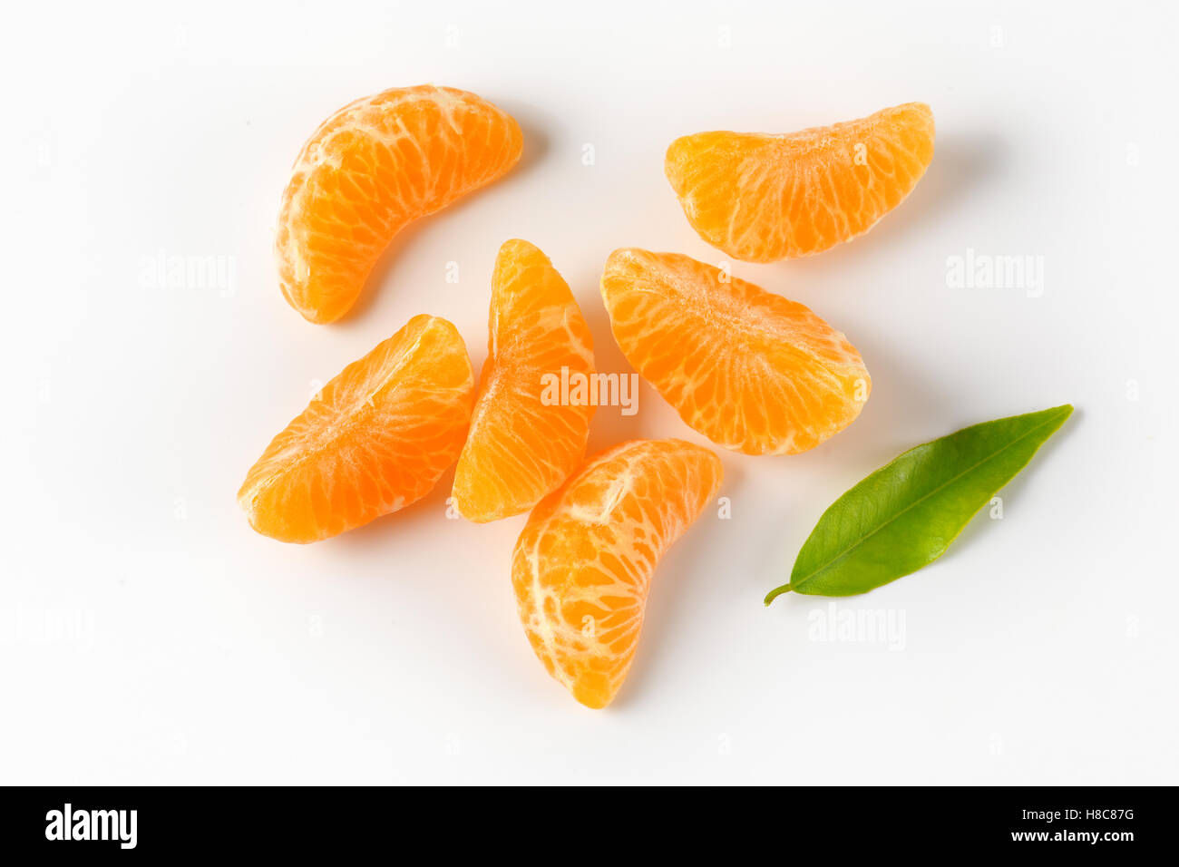 separated segments of tangerine on white background Stock Photo - Alamy