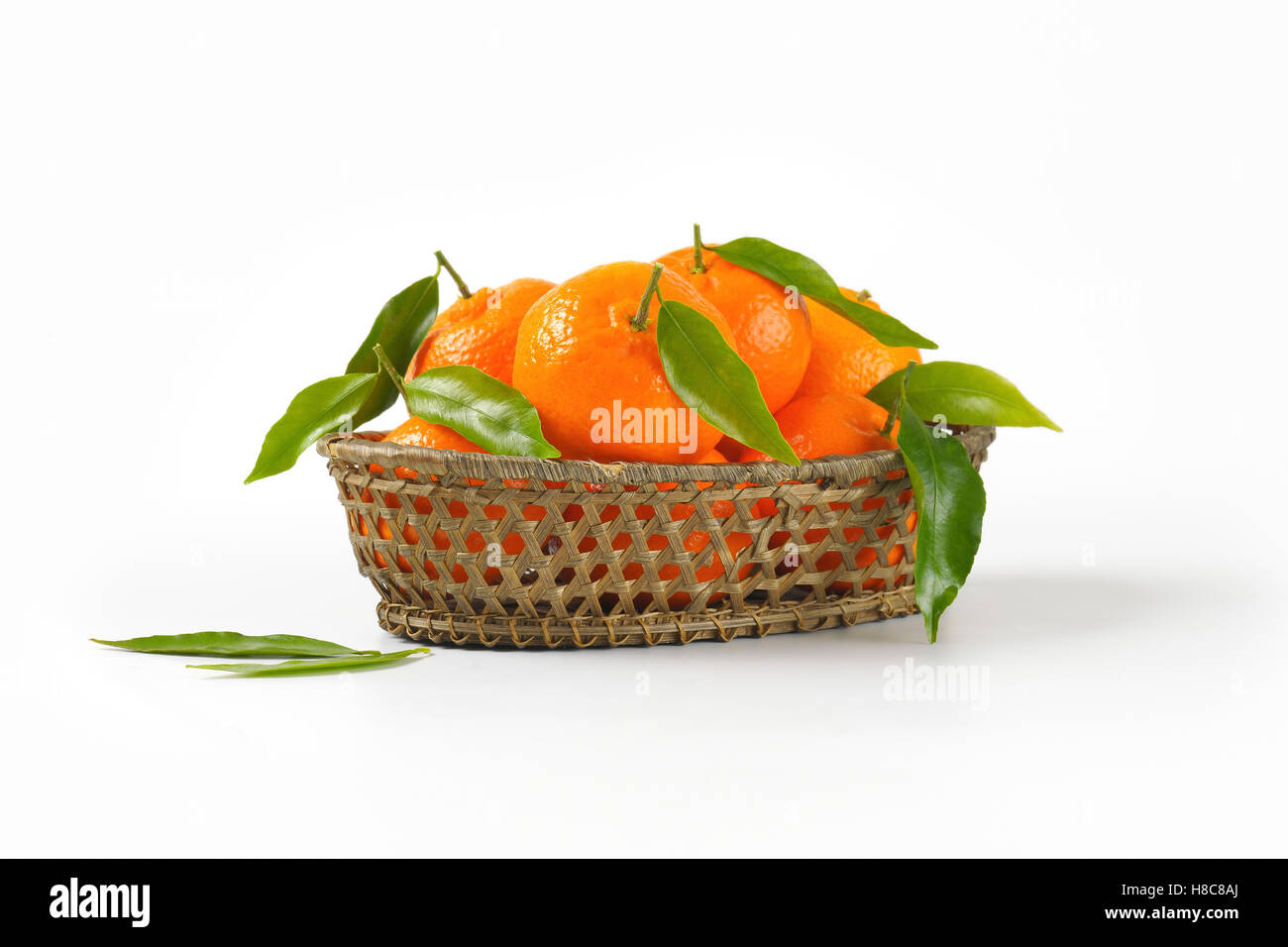 scuttle of ripe tangerines on white background Stock Photo - Alamy