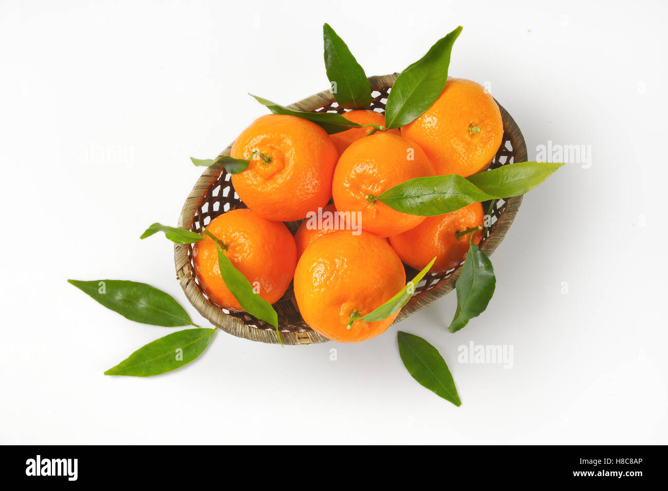 scuttle of ripe tangerines on white background Stock Photo - Alamy