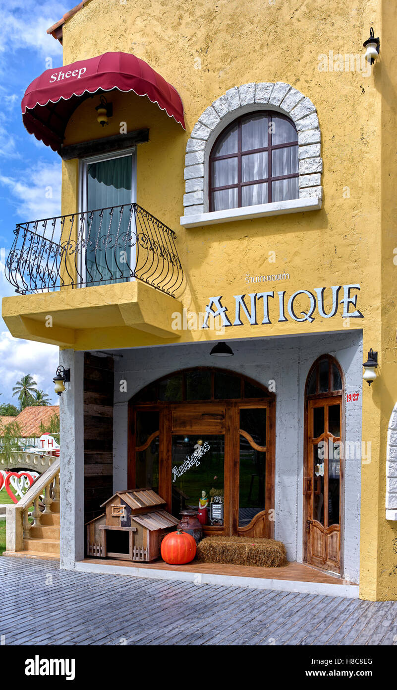 Colourful yellow facade of a freshly painted Antique shop Stock Photo ...