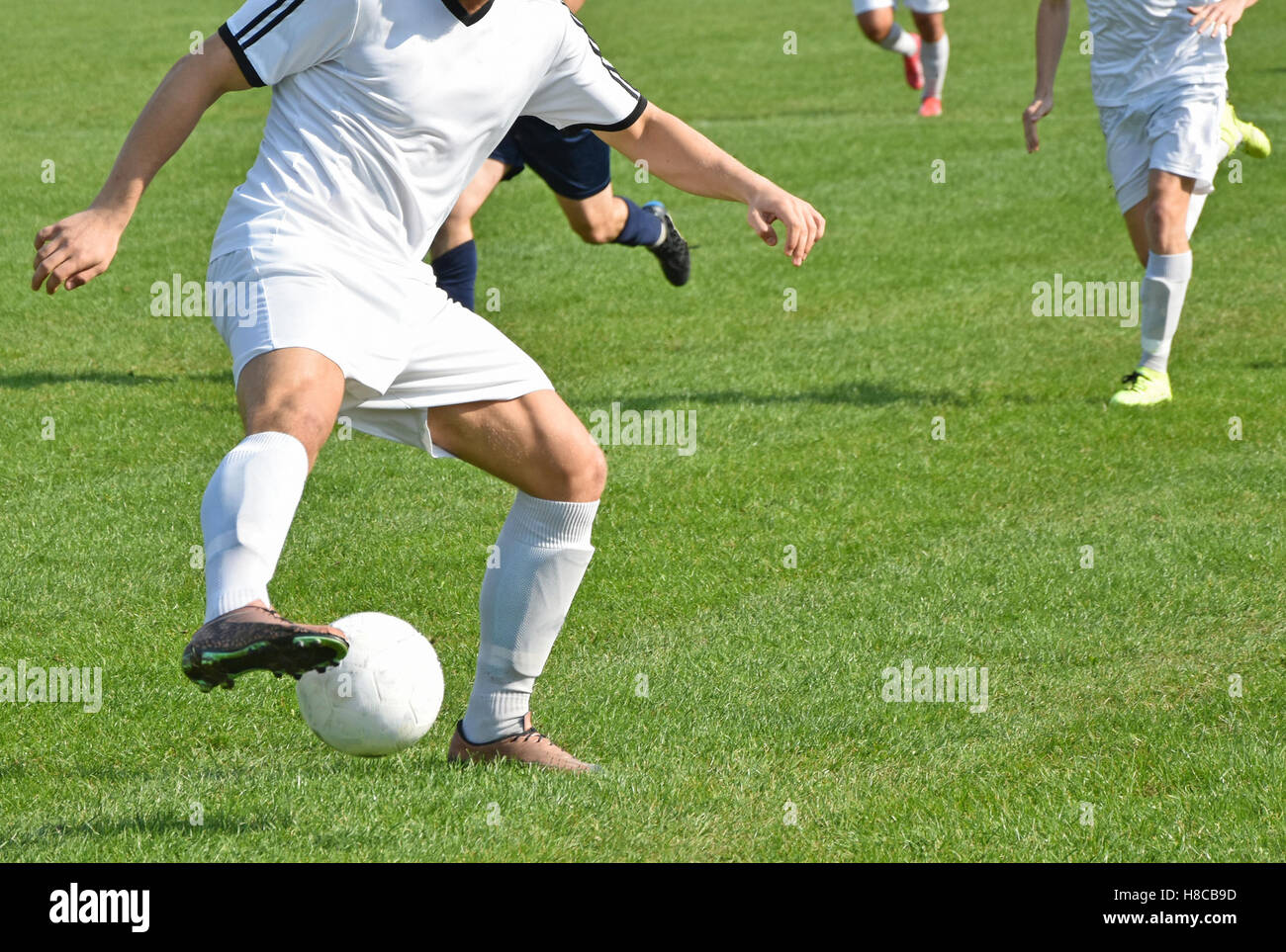 Men are playing soccer outdoors Stock Photo - Alamy
