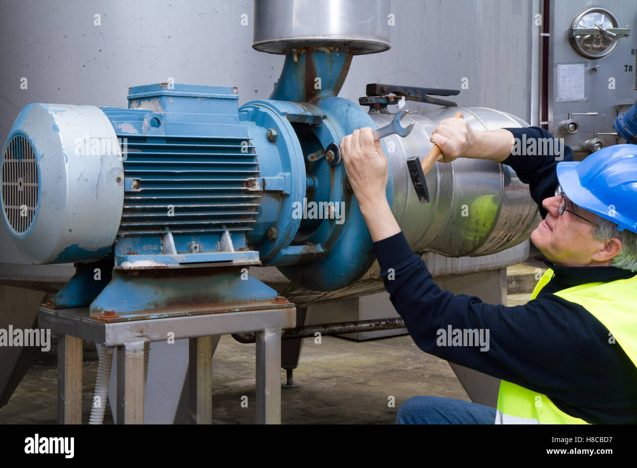 skilled worker making maintenance in industrila premises Stock Photo ...
