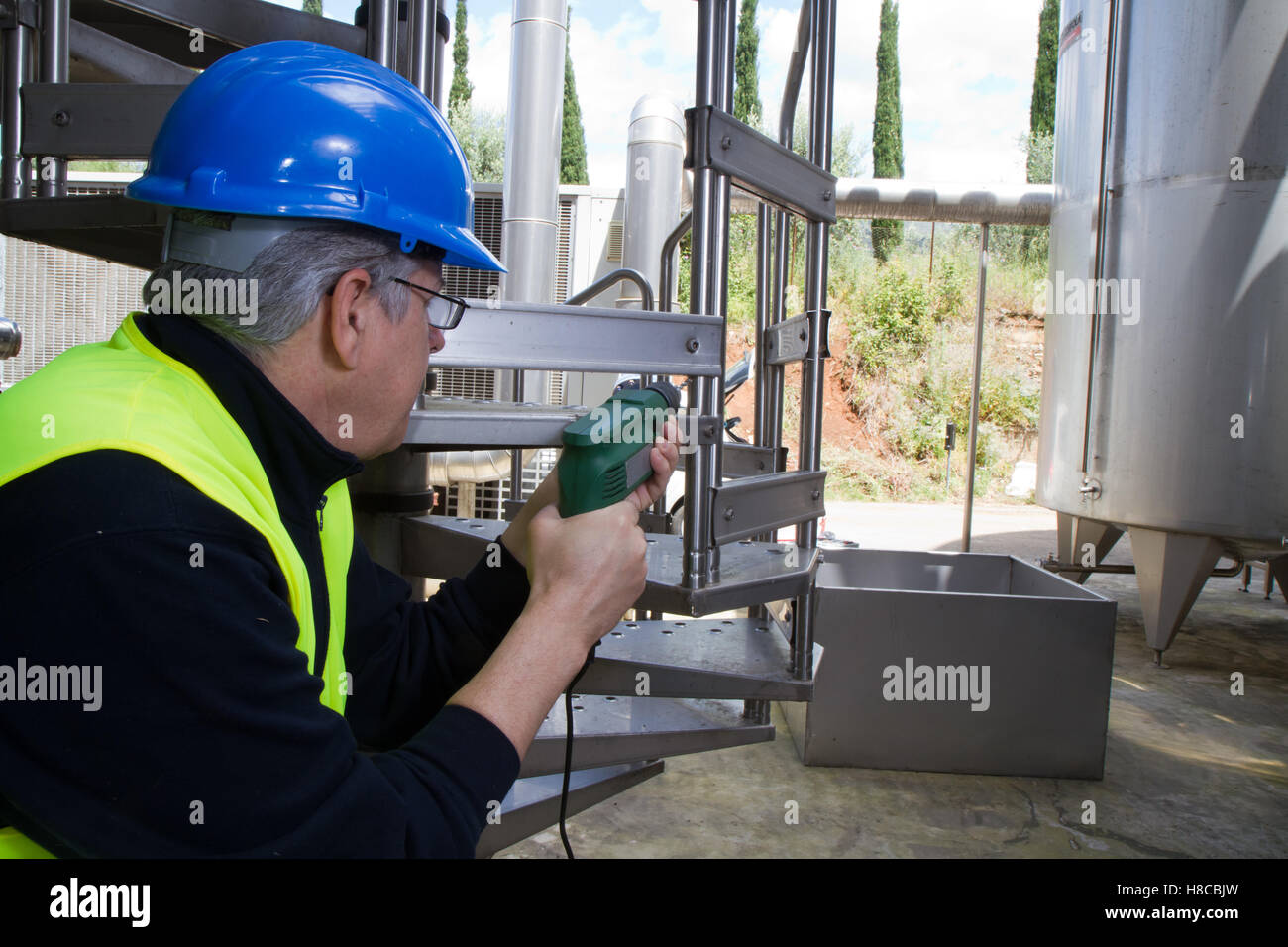skilled worker making maintenance in industrila premises Stock Photo ...