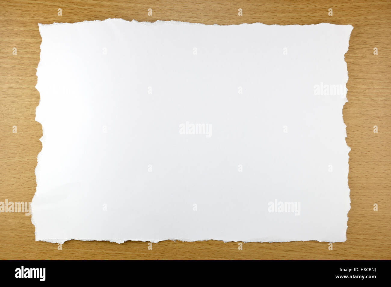 white paper tear on brown wood background and you can input text in ...