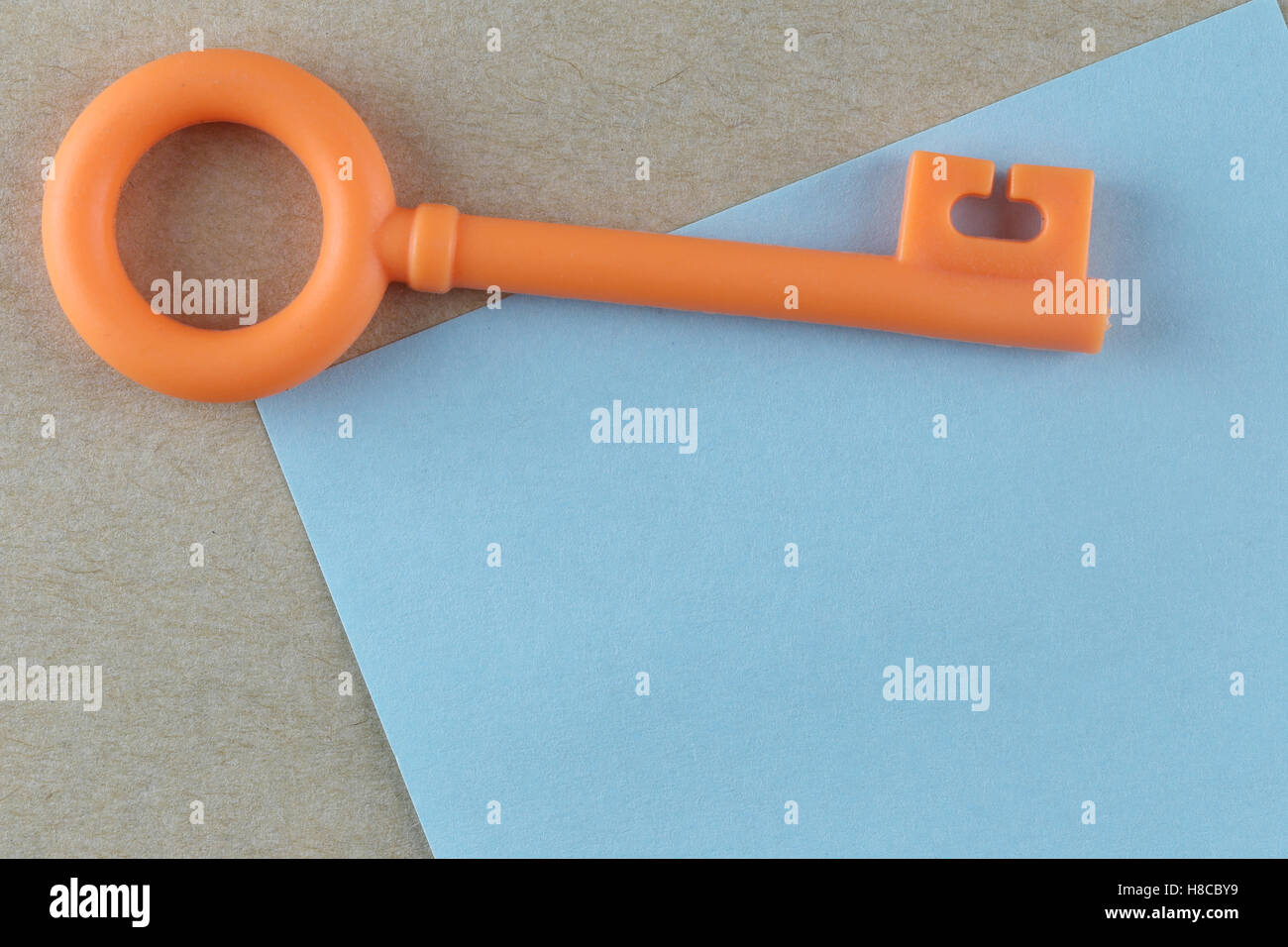 Orange Plastic key is placed on Blue Paper Note and can input text to ...