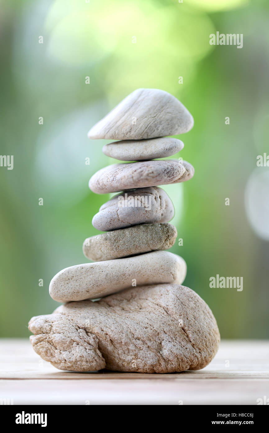 balance rock or zen stones on wooden floor and have nature green ...