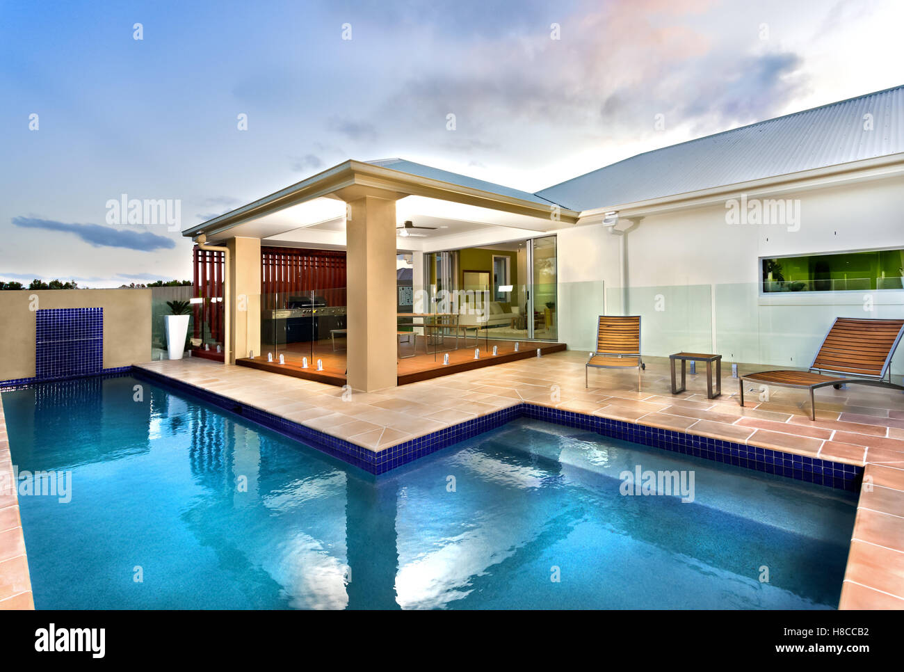 Blue water swimming pool is very clear and long also it is l shaped ...