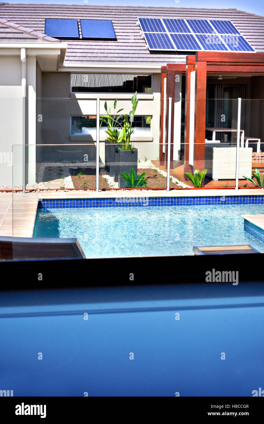 Modern house and a swimming pool with a patio area can be seen through ...