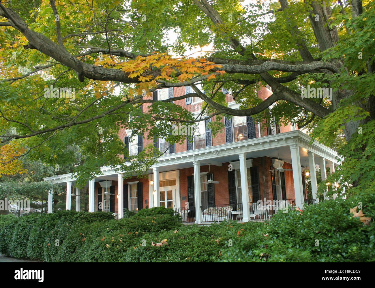 Exterior of country style house with veranda Stock Photo - Alamy