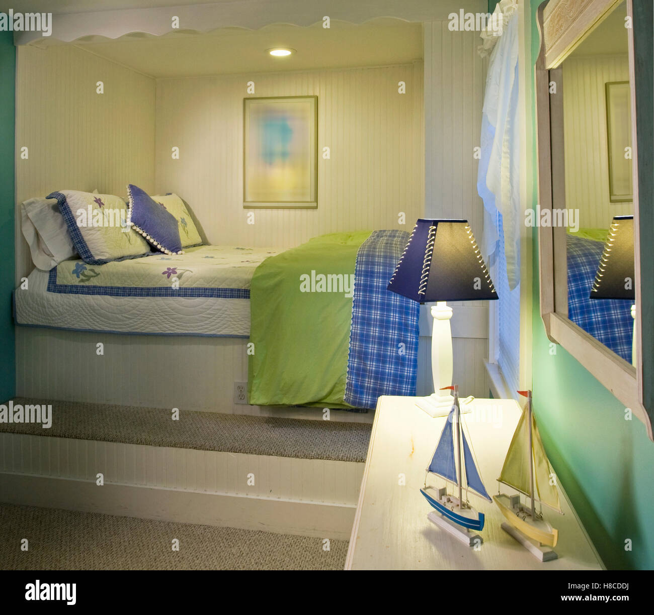 Double bed set in recess in yellow panelled bedroom Stock Photo - Alamy