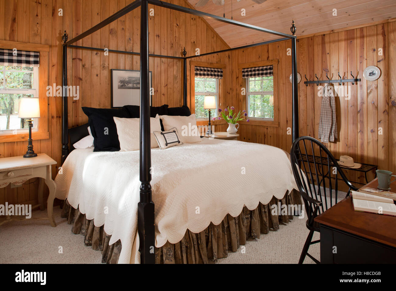 Wood paneled bedroom with four poster bed, Selah Ranch, Texas, USA ...