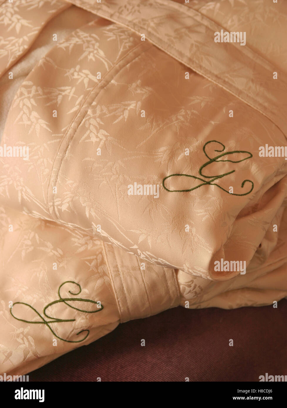 Floral pattern robe embroidered with the letter G at luxury inn Stock ...