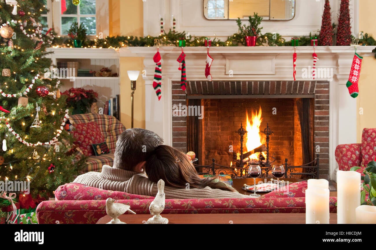 Couple cuddling fireplace hi-res stock photography and images - Alamy