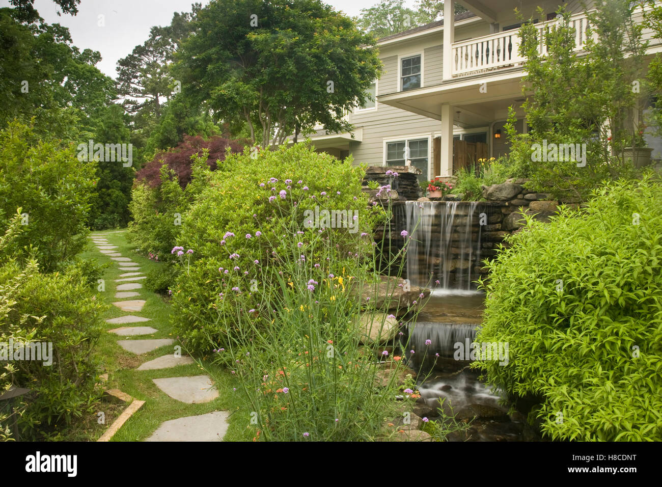 Exterior of country style house with waterfall in garden Stock Photo ...