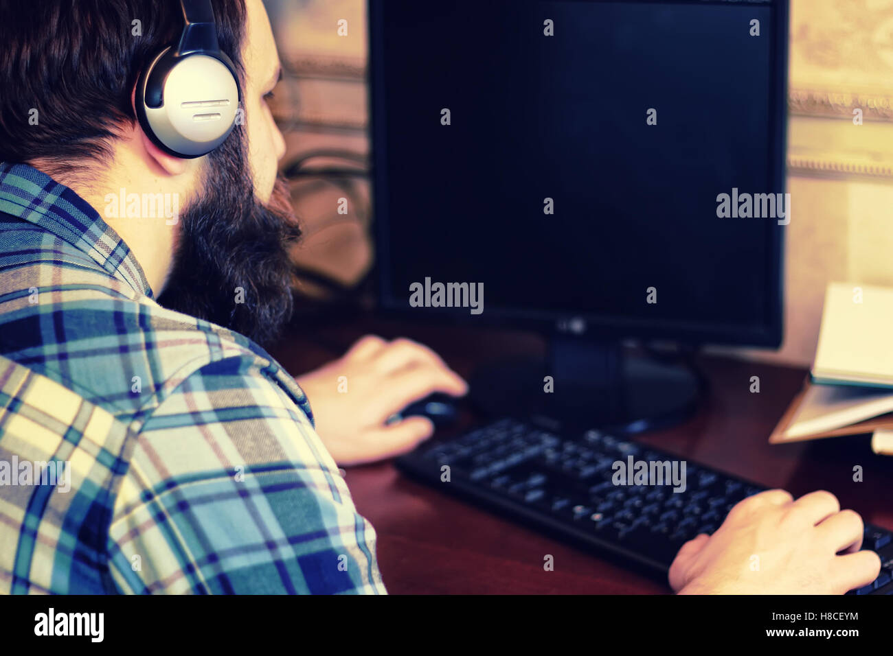male behind computer with headphones Stock Photo - Alamy