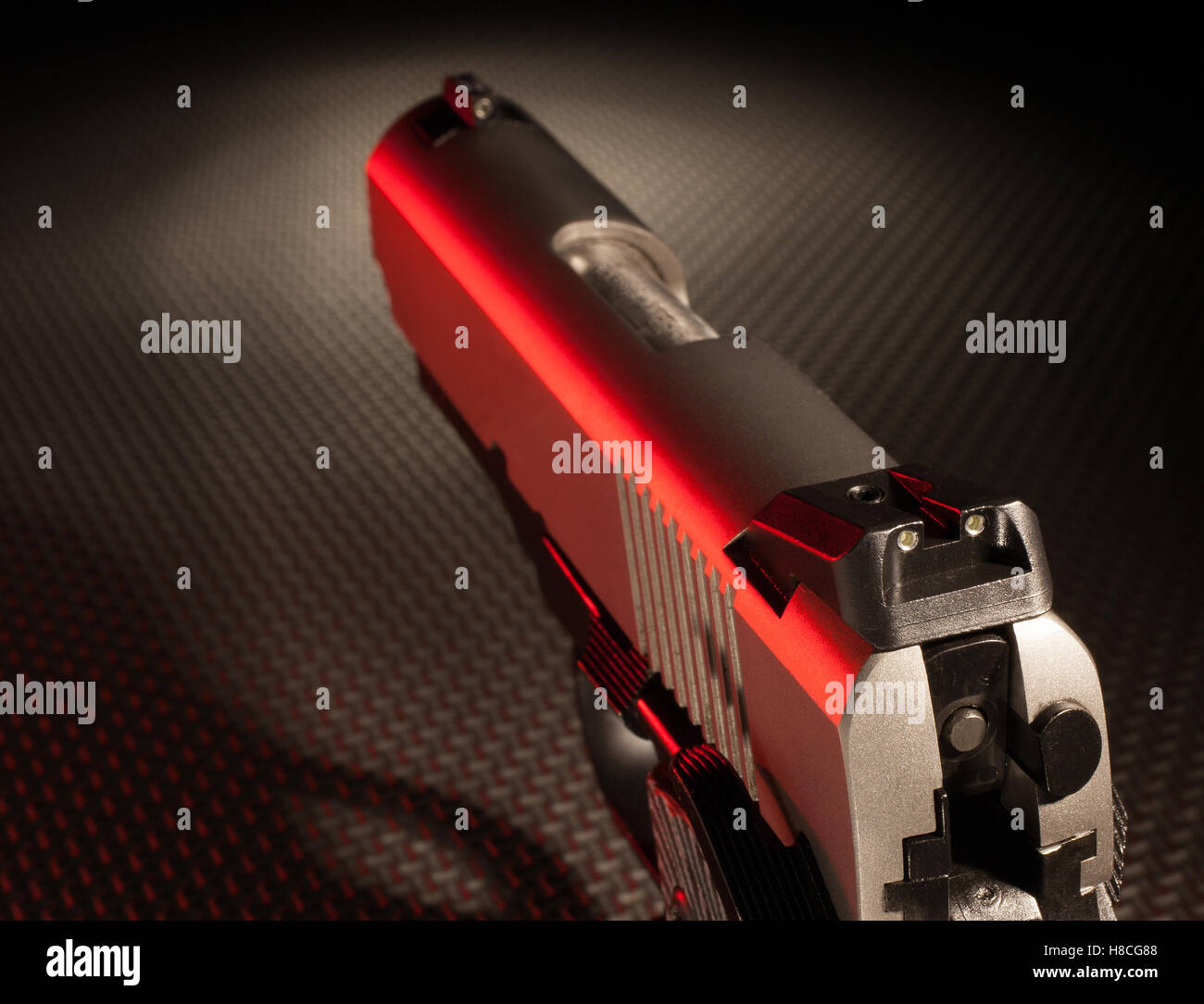 Semi automatic handgun with red highlights seen from the back sights ...