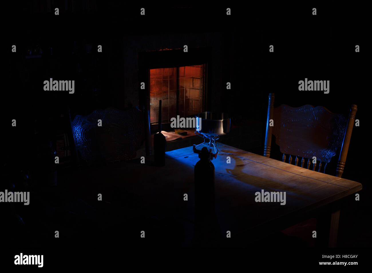 Dark house with a few lights and a fire in the fireplace Stock Photo ...