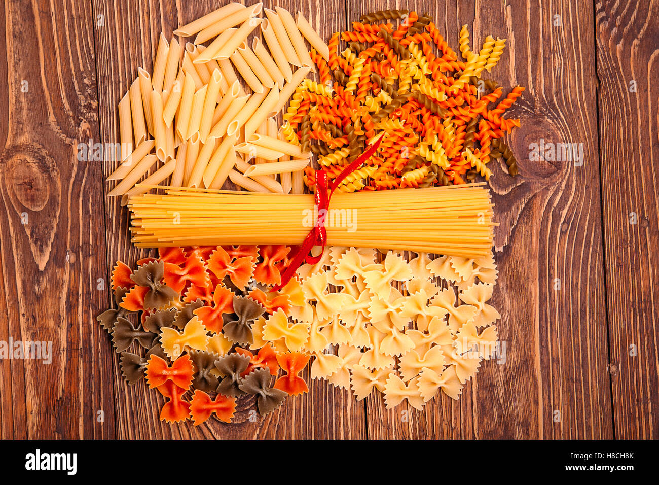 Spaghetti tied with a red ribbon, a number of different types of pasta ...