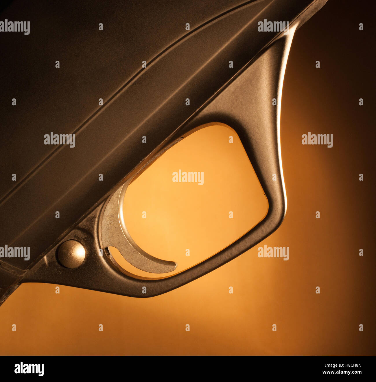 Firearm trigger that has a warm brown and tan background Stock Photo ...