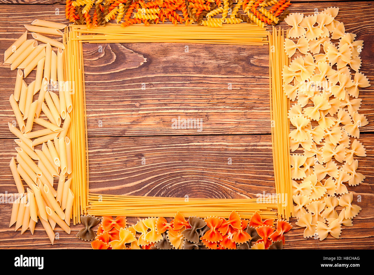 frame of spaghetti and pasta on retro wooden background. With copy ...