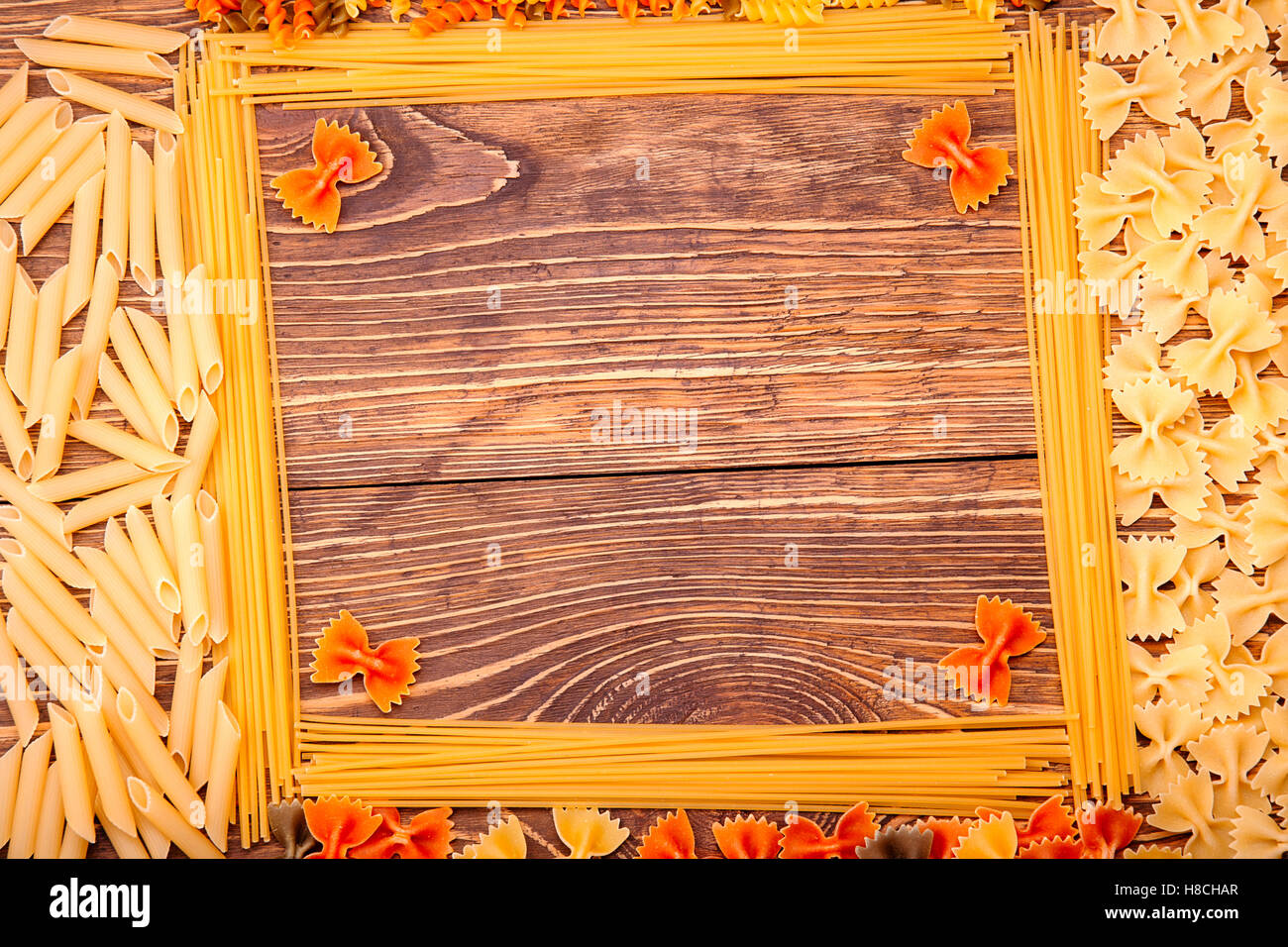 frame of spaghetti and pasta on retro wooden background. With copy ...