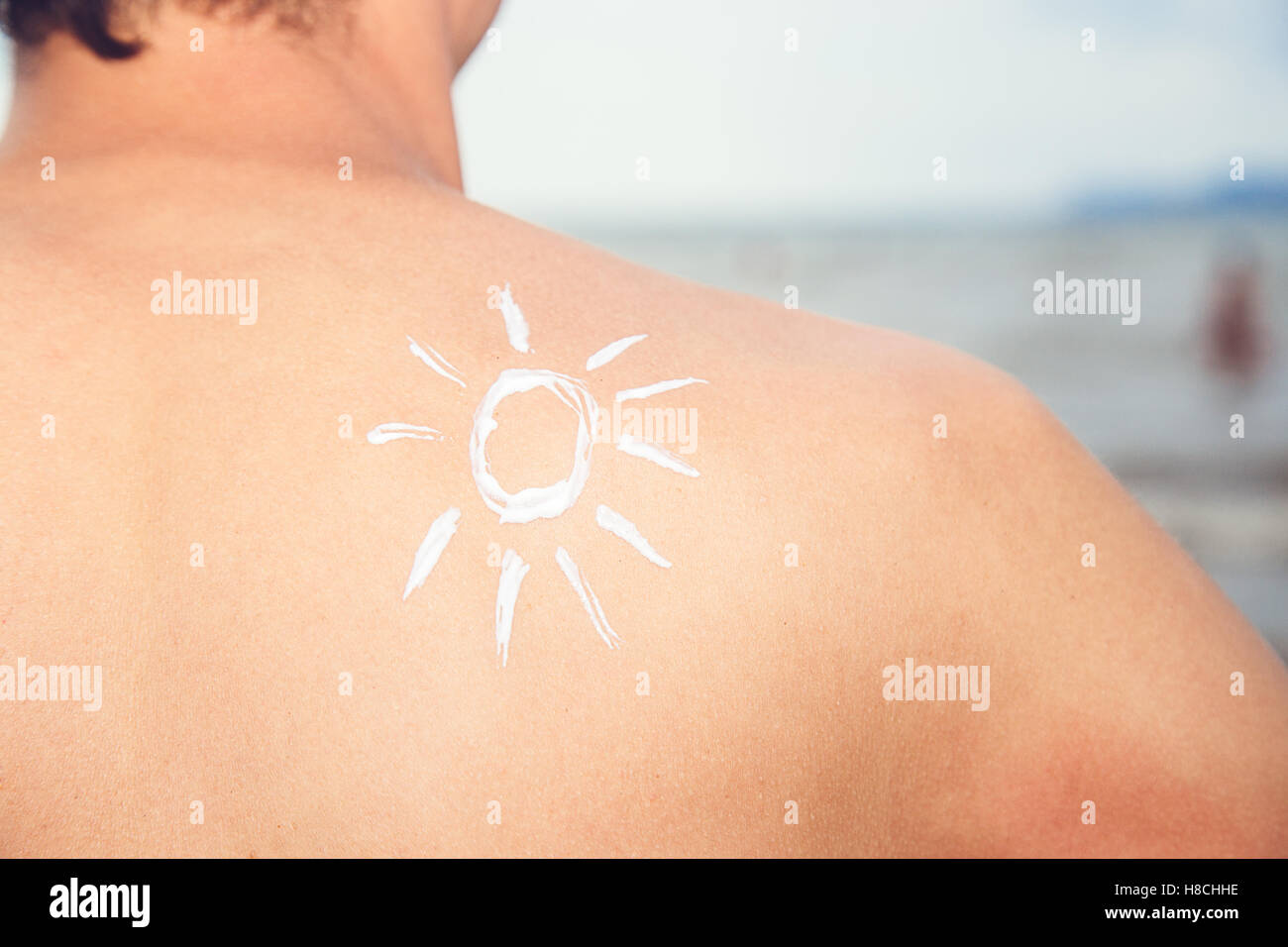 Lotion man with sunscreen with sun over sea background Stock Photo - Alamy