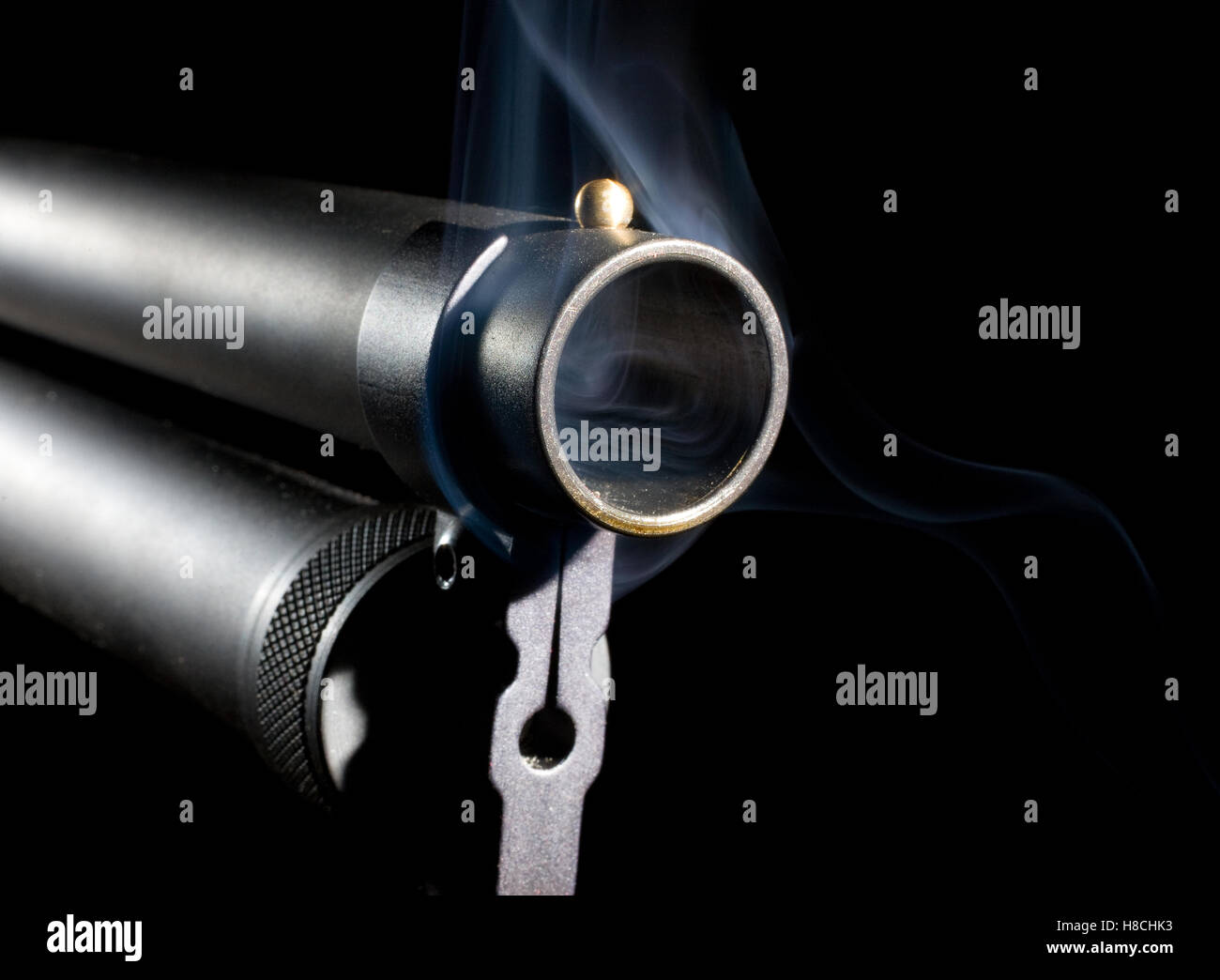 Single barrel from a shotgun that has smoke around it Stock Photo - Alamy