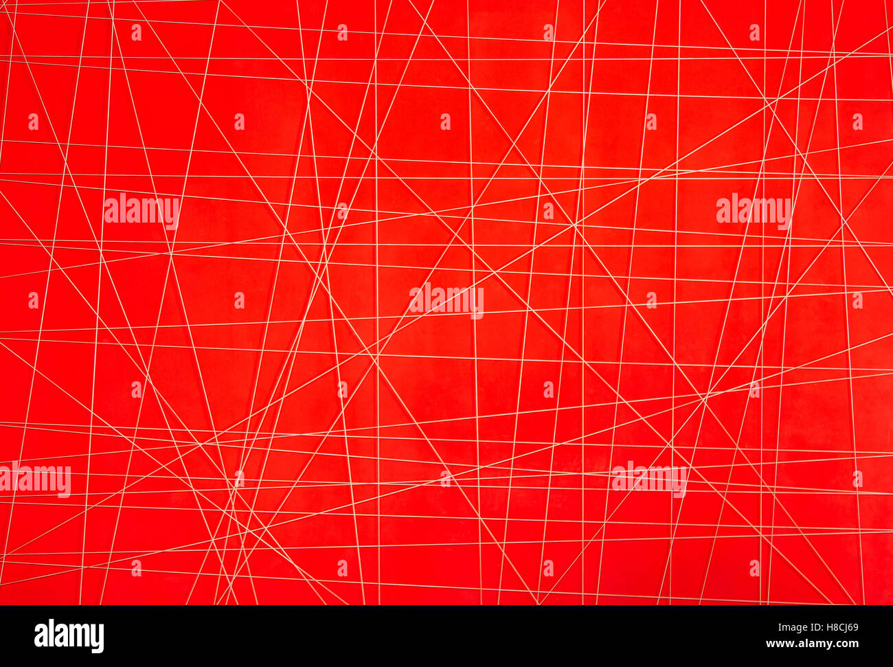 abstract white thread with irregular crossed lines on red background ...