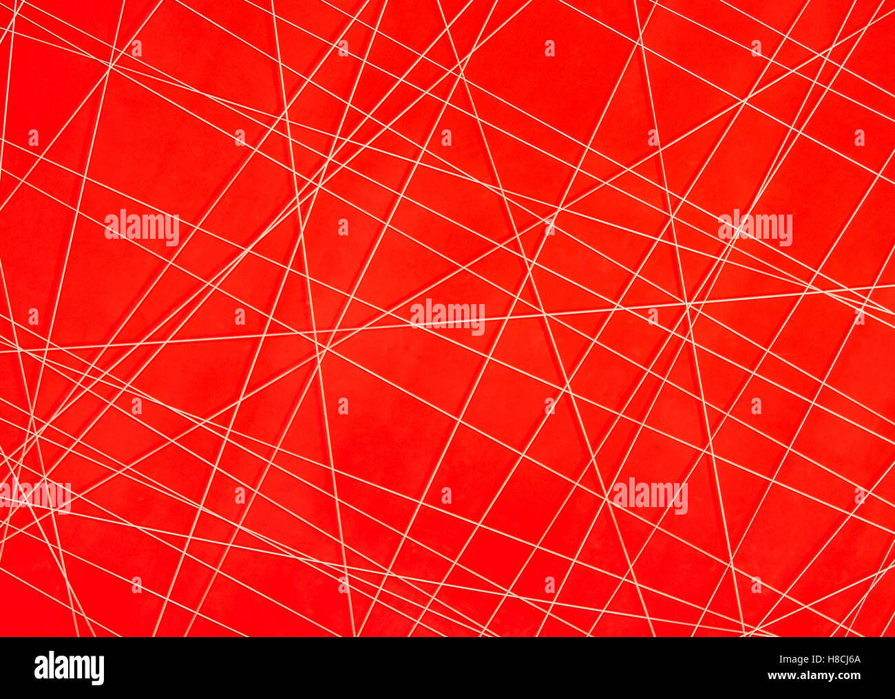 abstract white thread with irregular crossed lines on red background ...