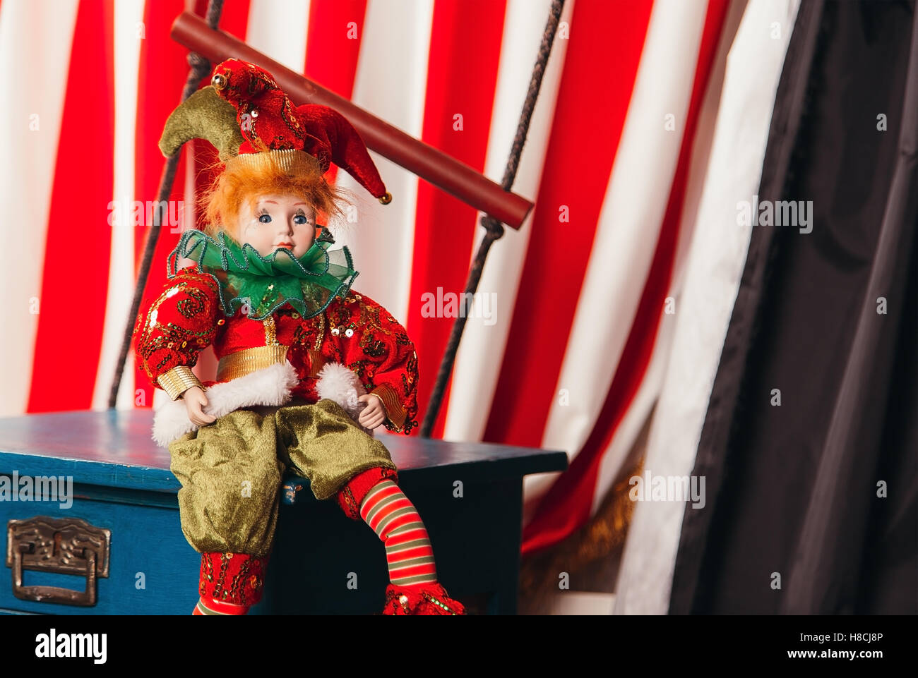 clown sitting on a bedside table in the circus Stock Photo - Alamy