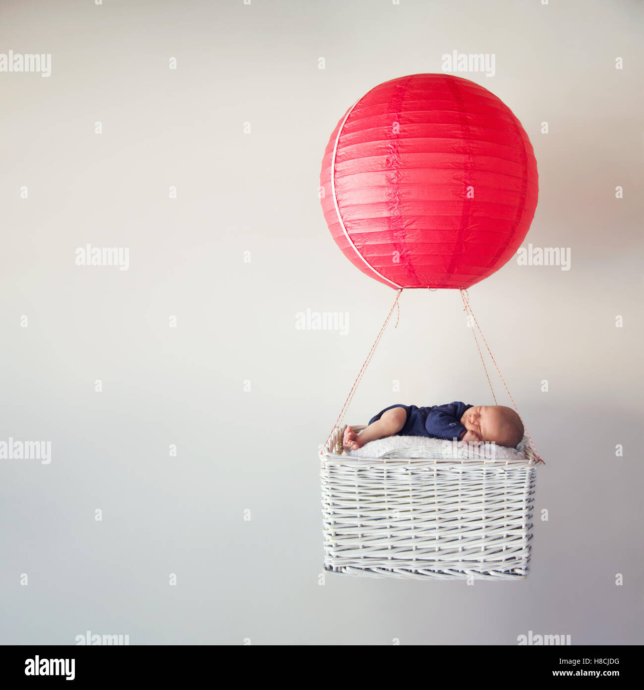 Newborn baby sleeping in a tiny basket of an air balloon Stock Photo ...