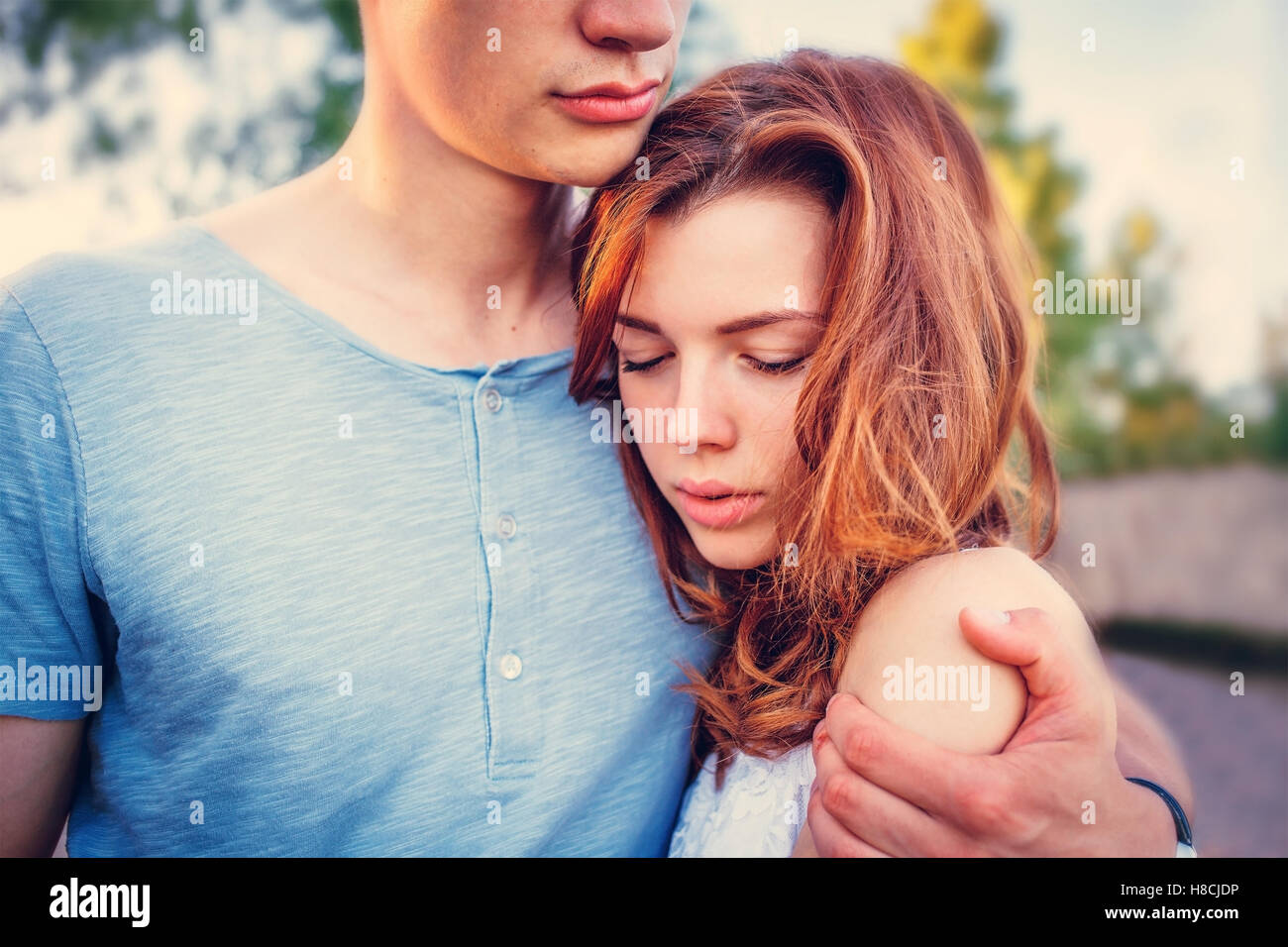 Sad woman hugging her boyfriend and looking down couple problems ...