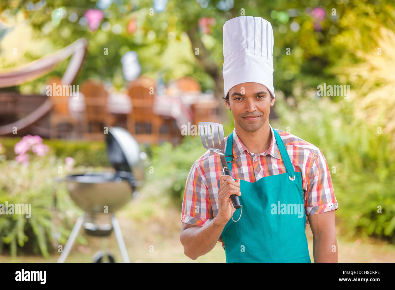 Handsome man preparing barbecue for friends, France Stock Photo - Alamy