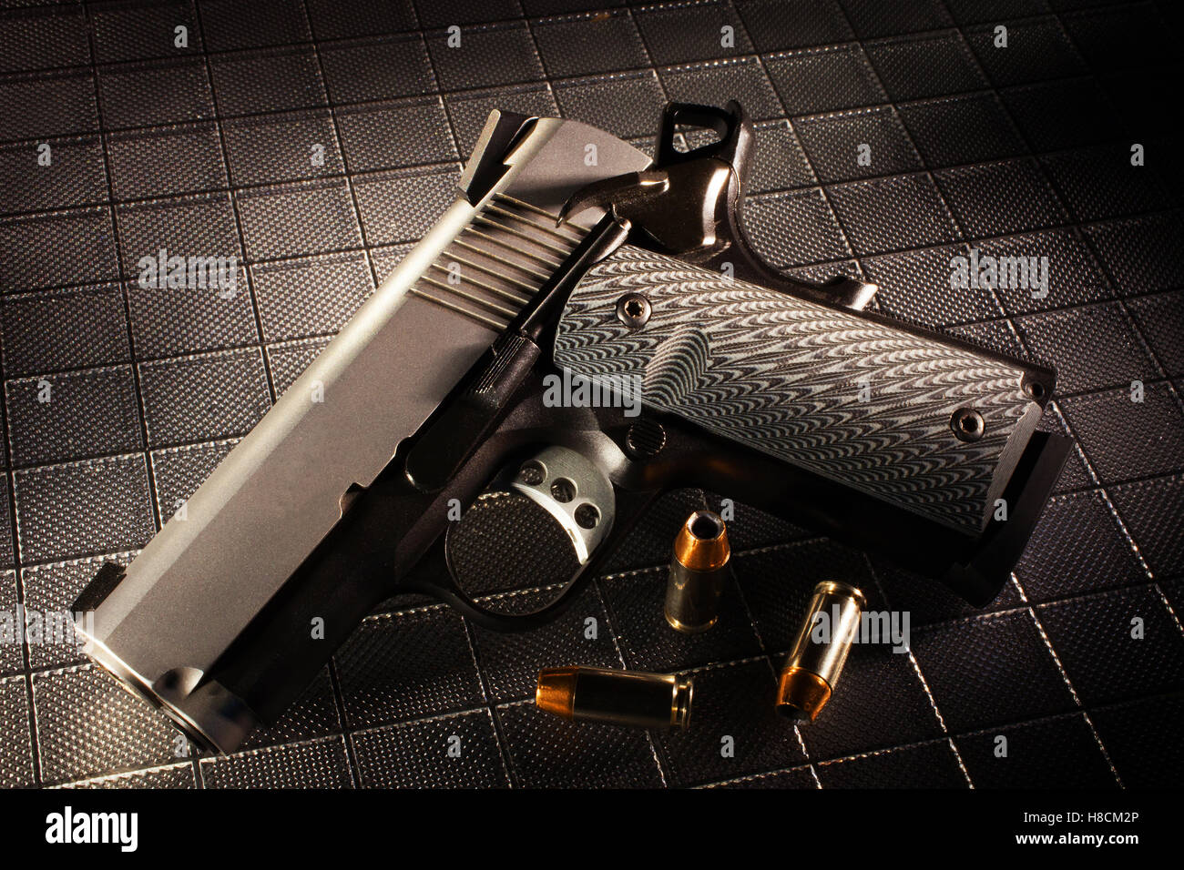 Semi automatic handgun that is on textured plastic Stock Photo - Alamy