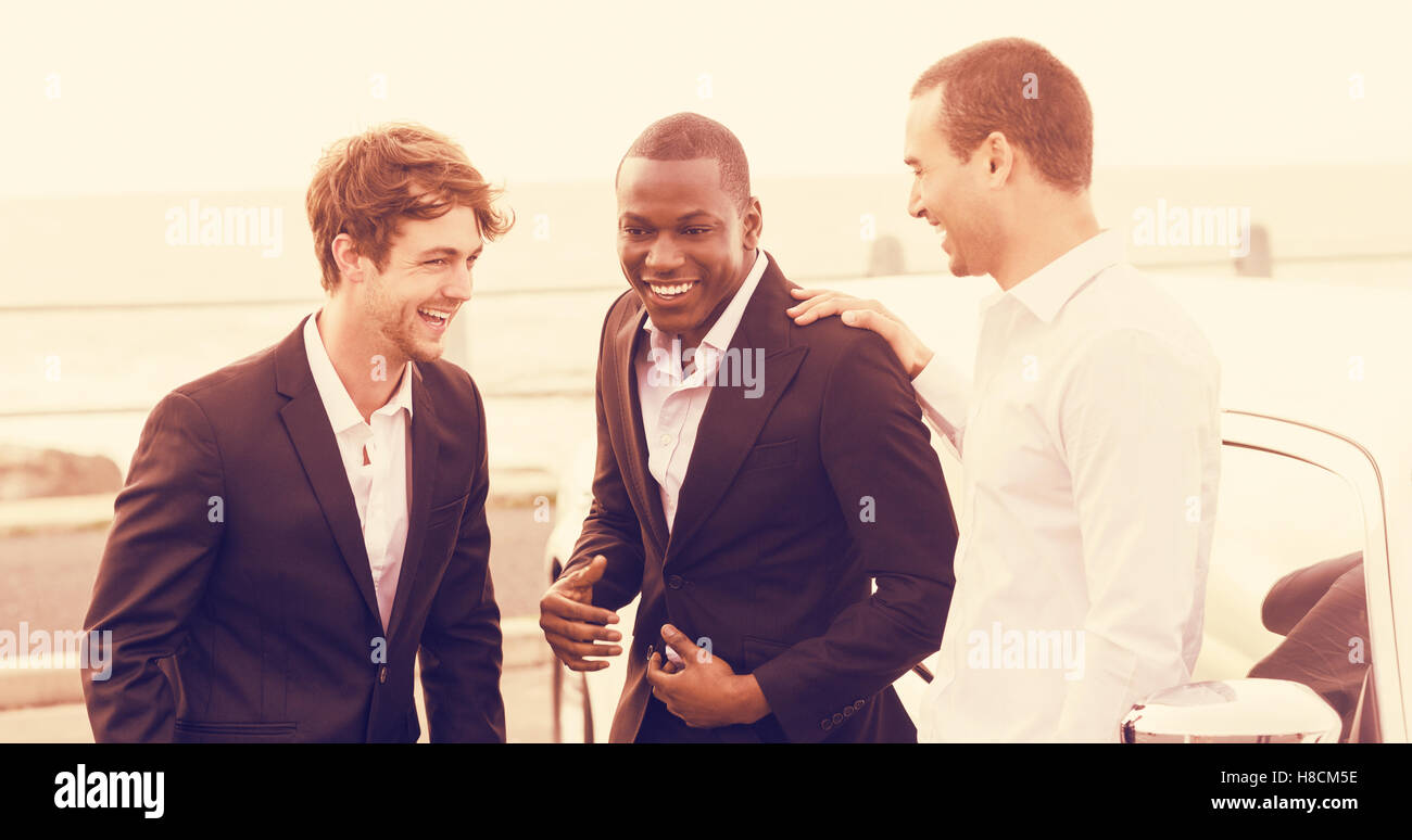 Cheerful friends talking while standing Stock Photo - Alamy