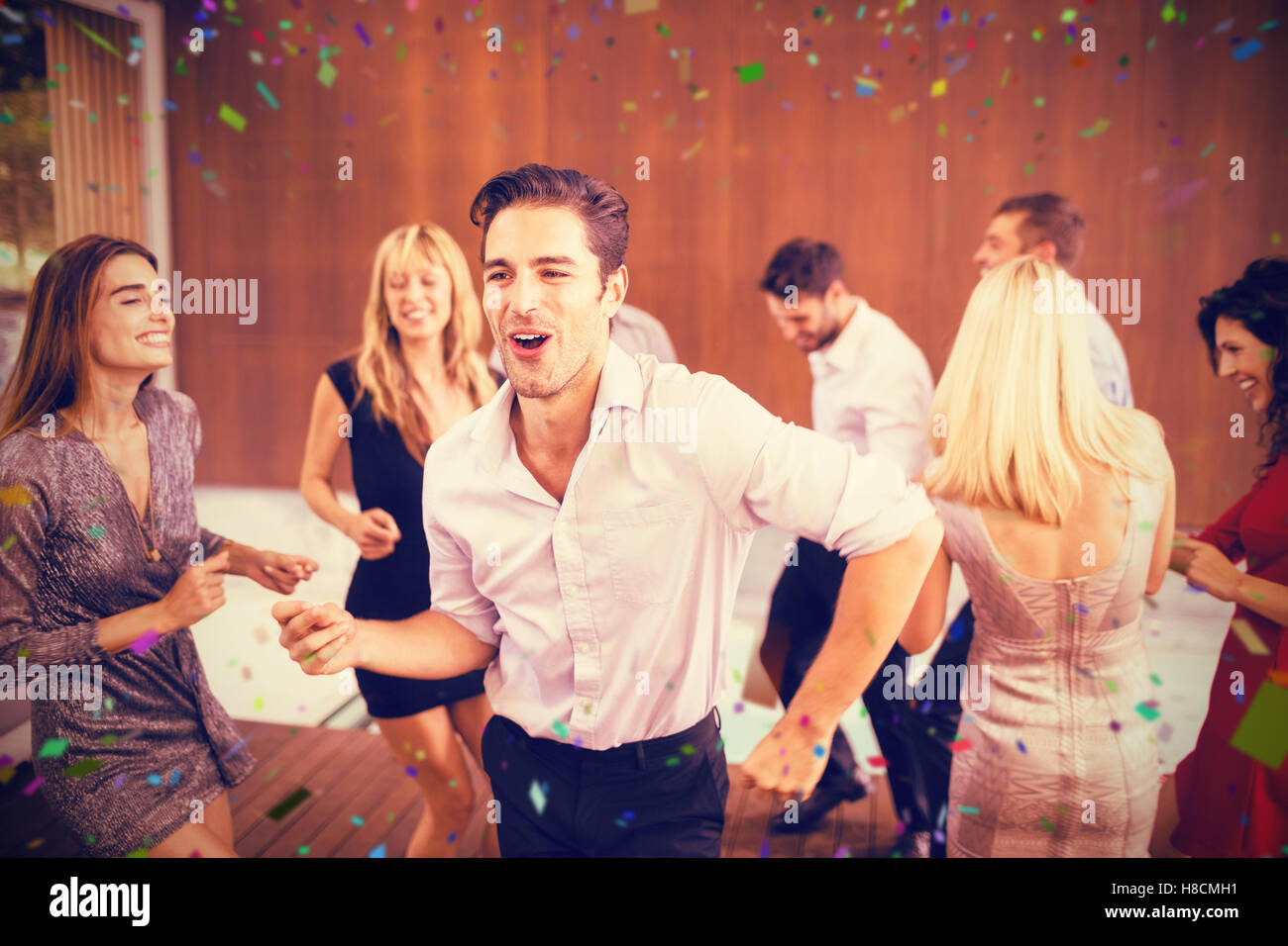 Composite image of young friends having fun at party Stock Photo - Alamy