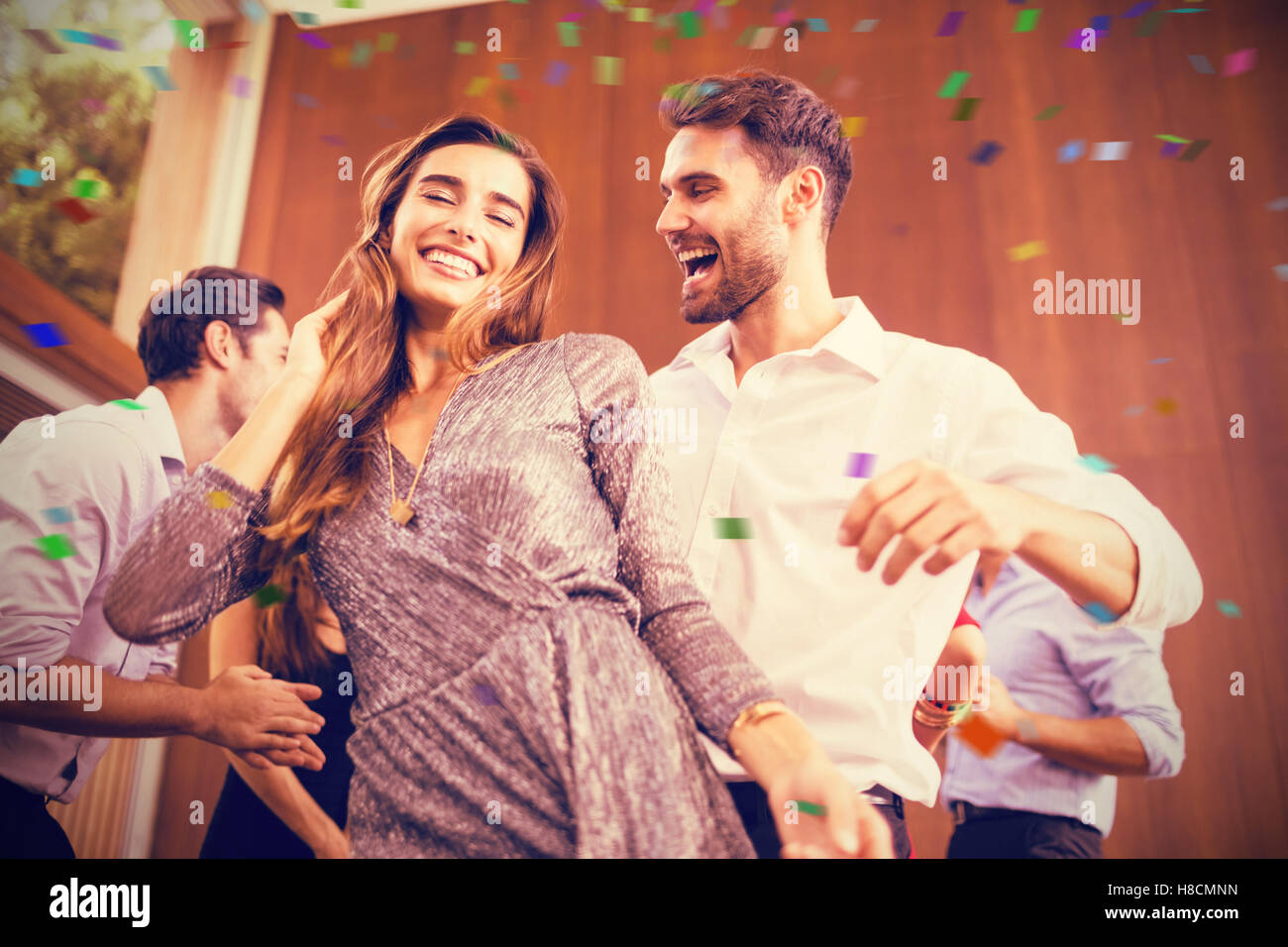 Composite image of cheerful young friends dancing together Stock Photo ...