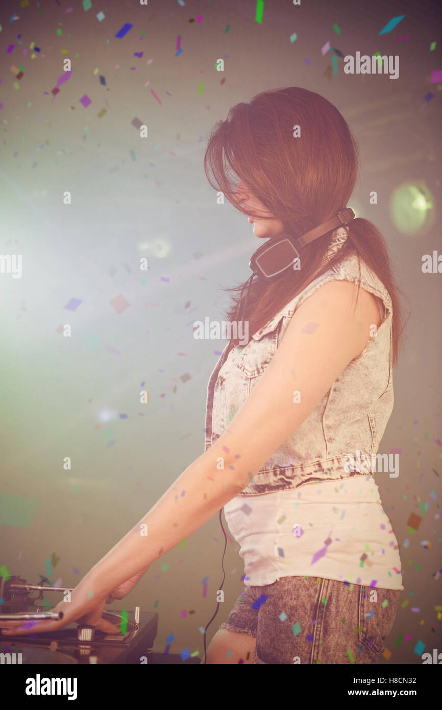 Composite image of side view of female dj playing music Stock Photo - Alamy