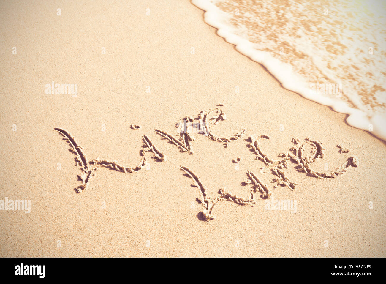 Live life written text on sand Stock Photo - Alamy