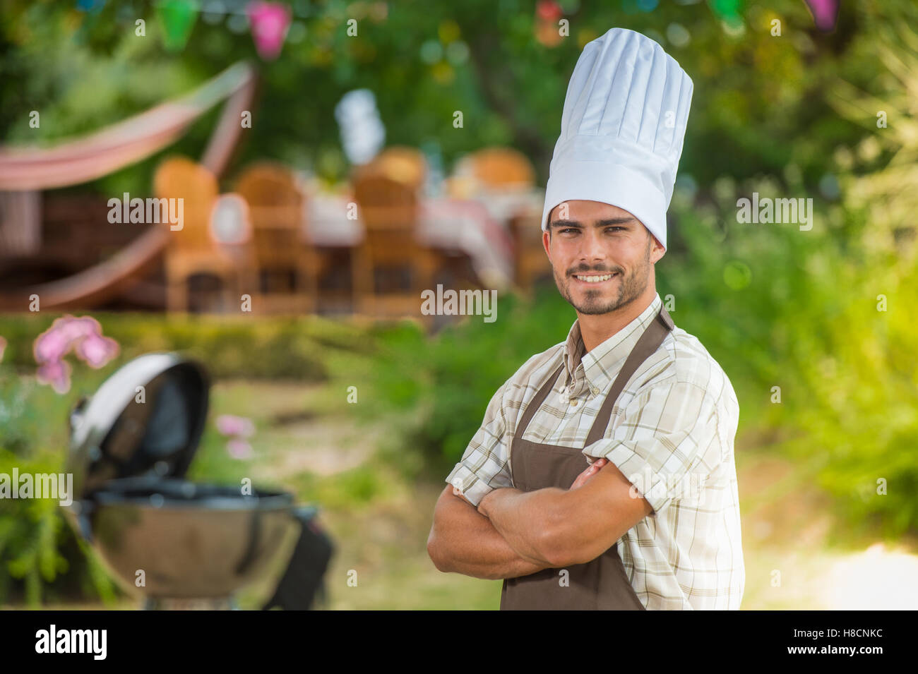 Handsome man preparing barbecue for friends, France Stock Photo - Alamy