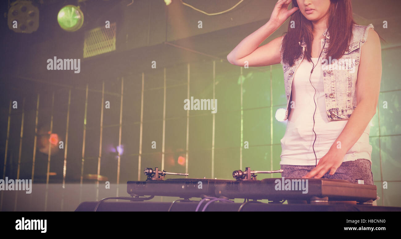 Pretty female DJ playing music Stock Photo - Alamy