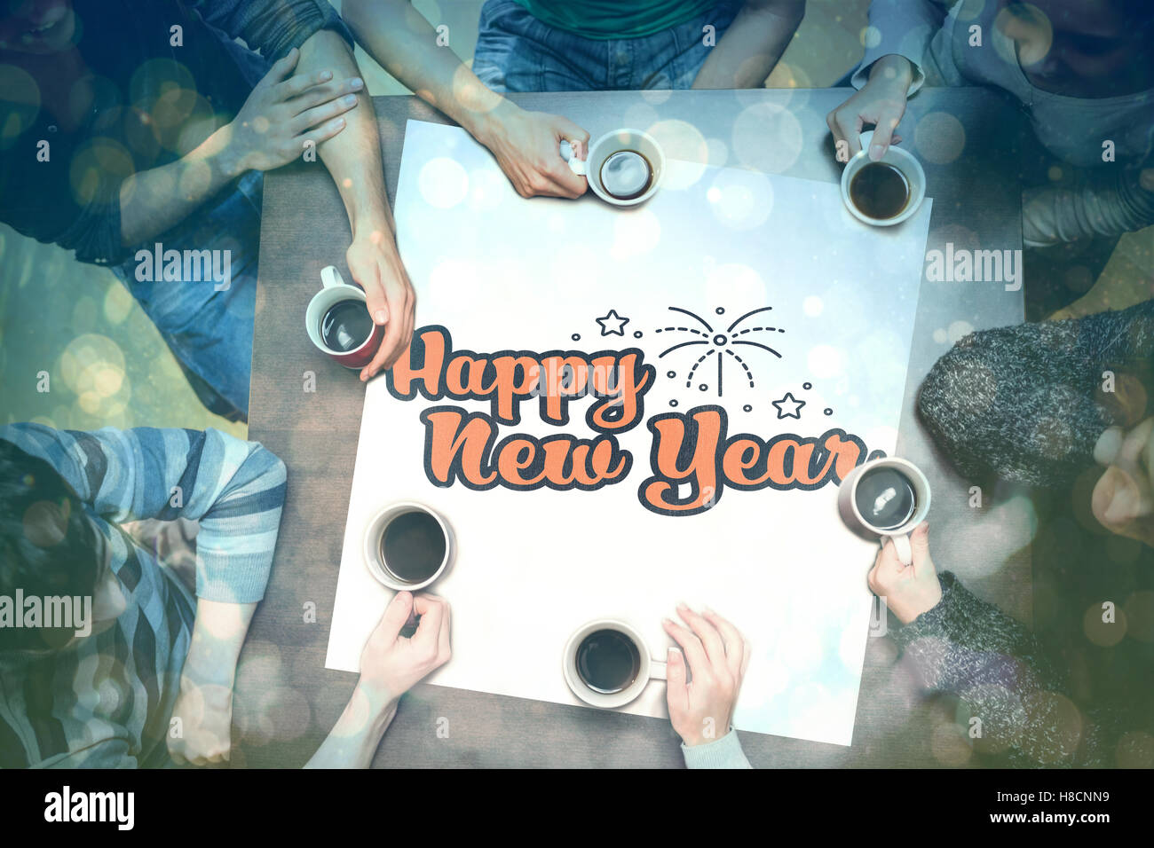 People drinking coffee around new year message Stock Photo - Alamy