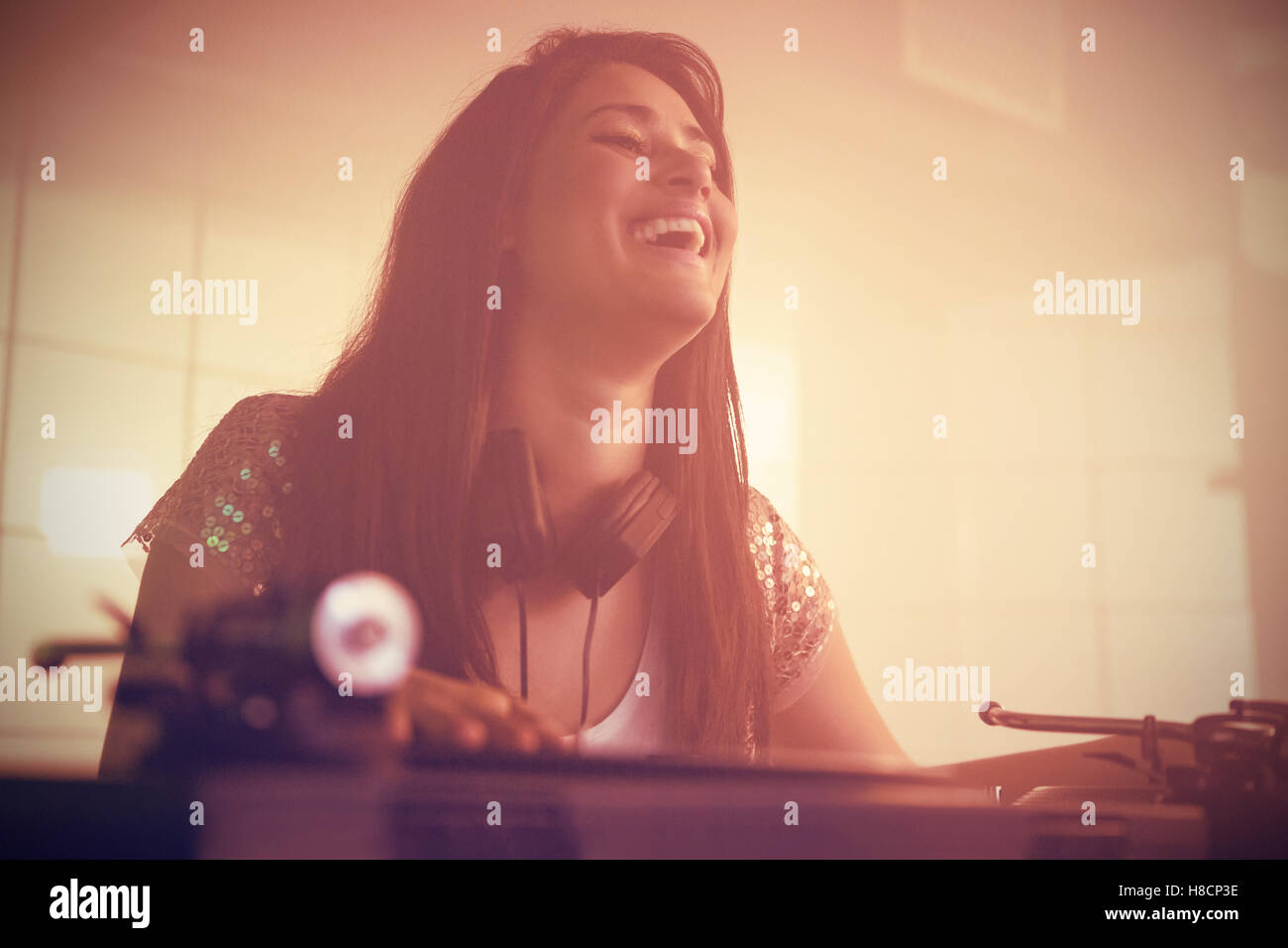 Pretty female DJ playing music Stock Photo - Alamy