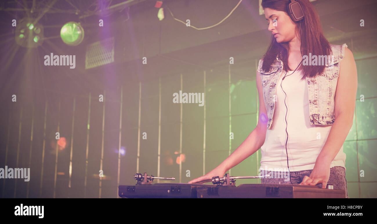 Pretty female DJ playing music Stock Photo - Alamy