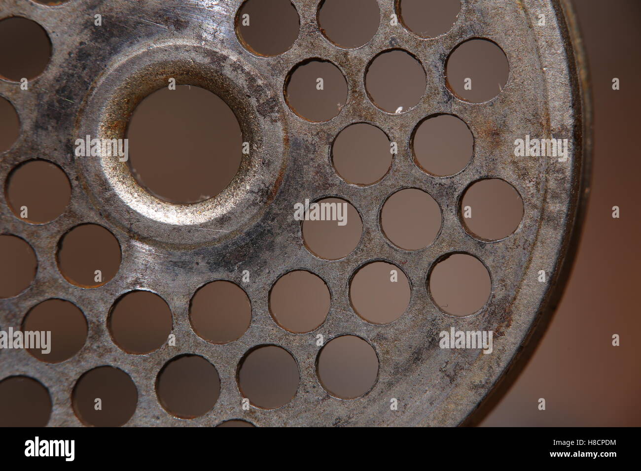 Perforated disk used as part of an old meat grinder Stock Photo - Alamy