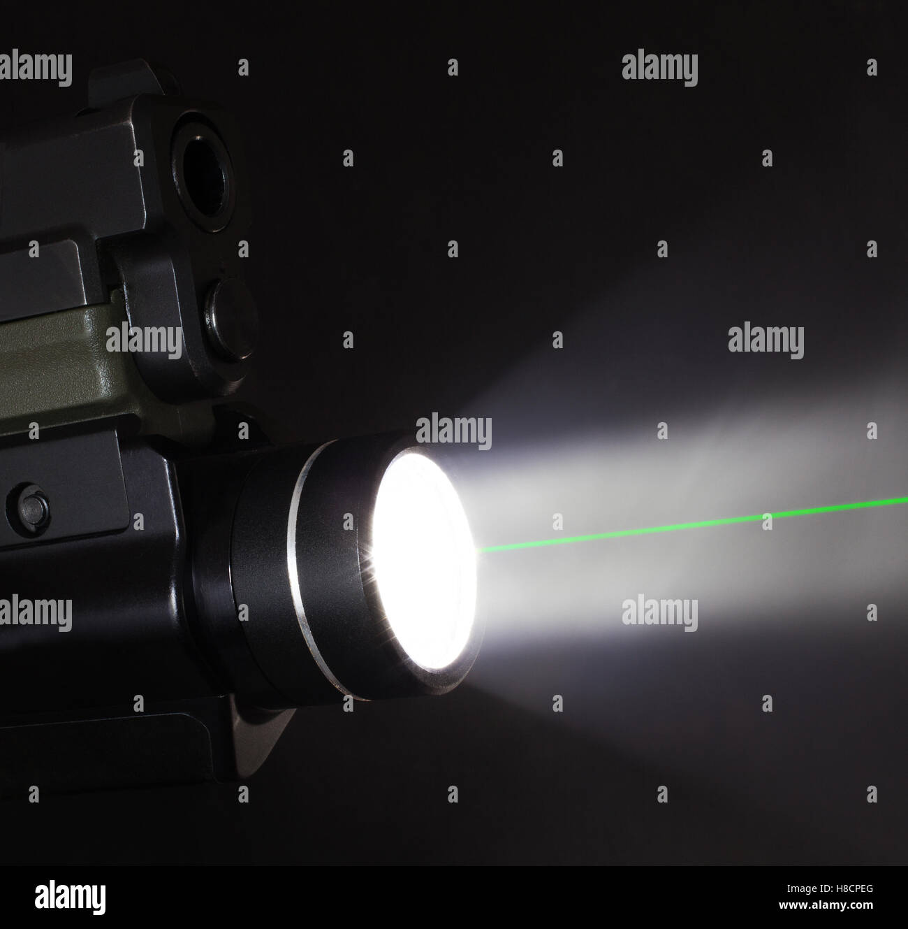 Green laser coming from a weaponlight on a handgun Stock Photo - Alamy